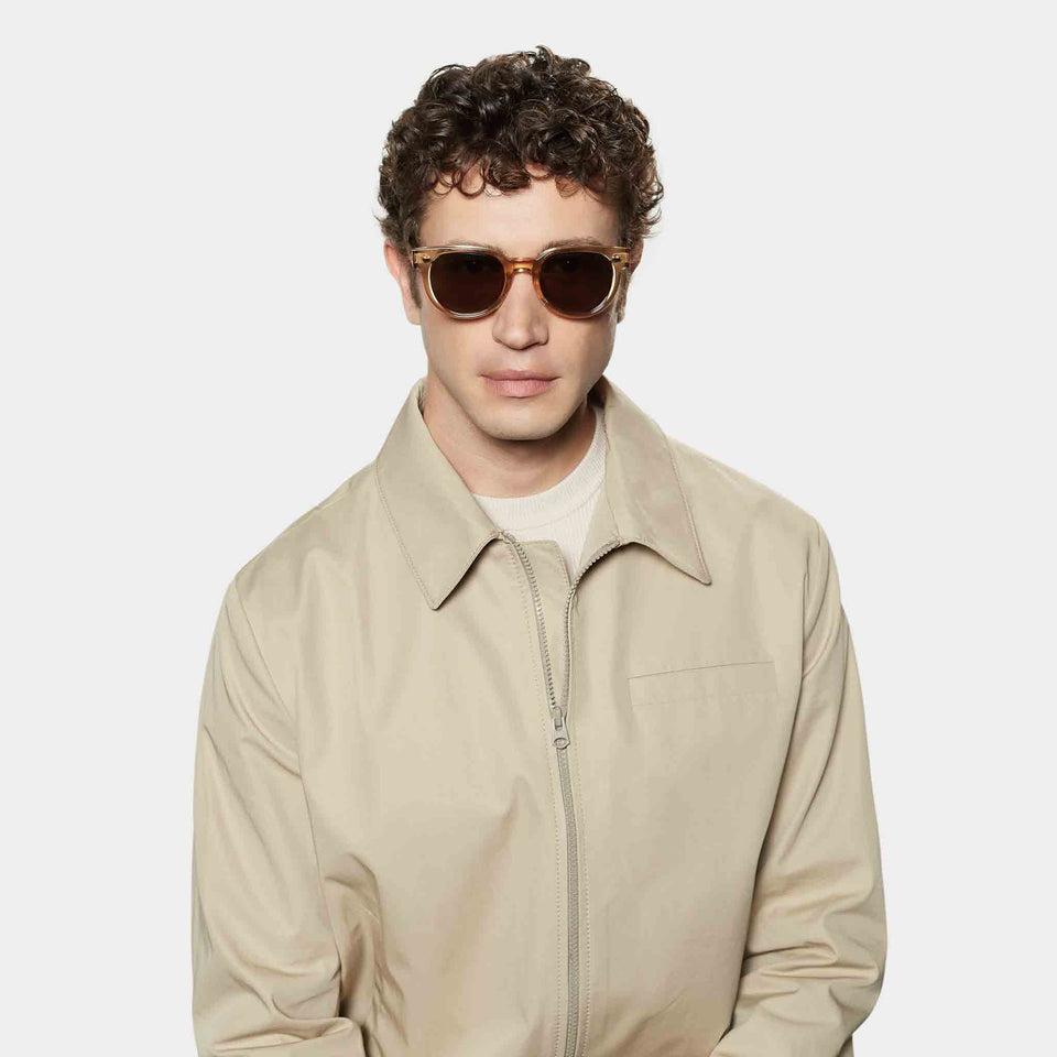 Round champagne-colored sustainable sunglasses: Palm | TBD Eyewear
